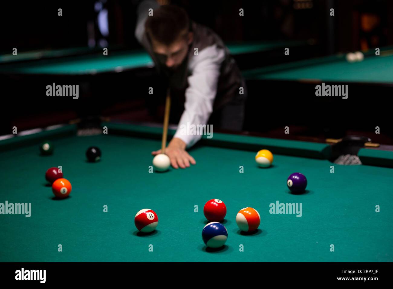Medium shot guy with pool cue playing billiard Stock Photo - Alamy