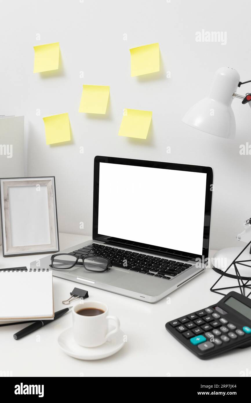 Side view desk arrangement with post its wall Stock Photo - Alamy