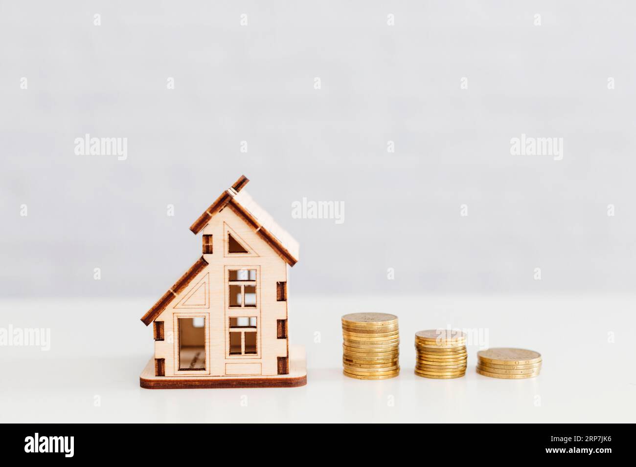 Stacked coins wooden home Stock Photo - Alamy Stacked coins wooden home Stock Photo - Alamy