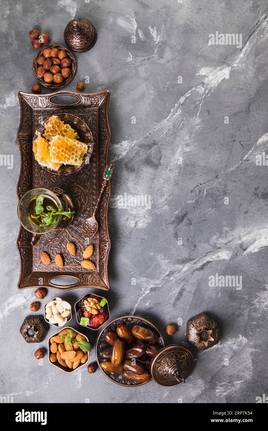 Tea glass with dates fruit honeycomb Stock Photo - Alamy