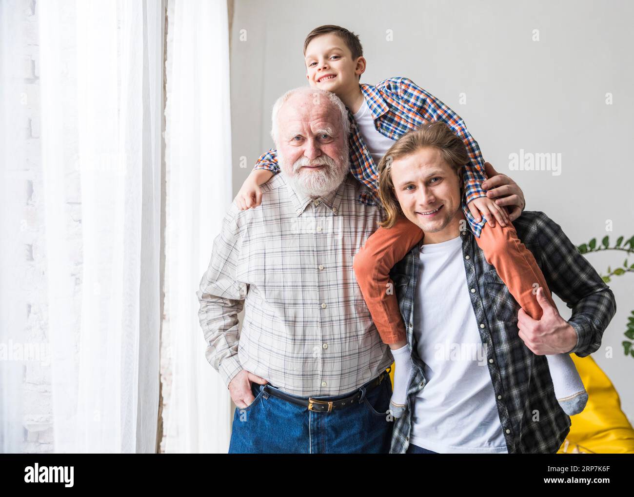 Men different generations standing embracing Stock Photo - Alamy