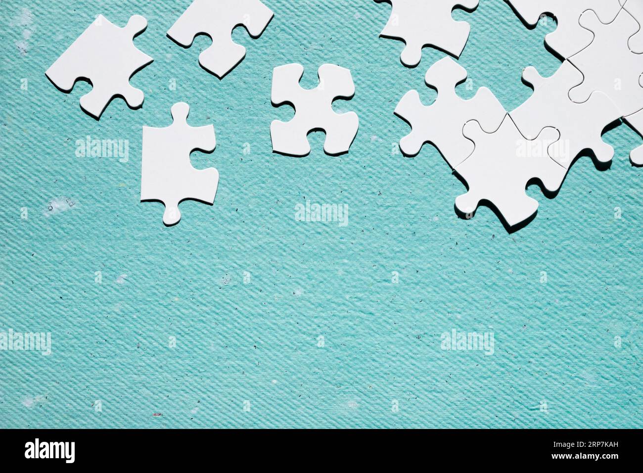 White jigsaw puzzle piece blue textured surface Stock Photo - Alamy