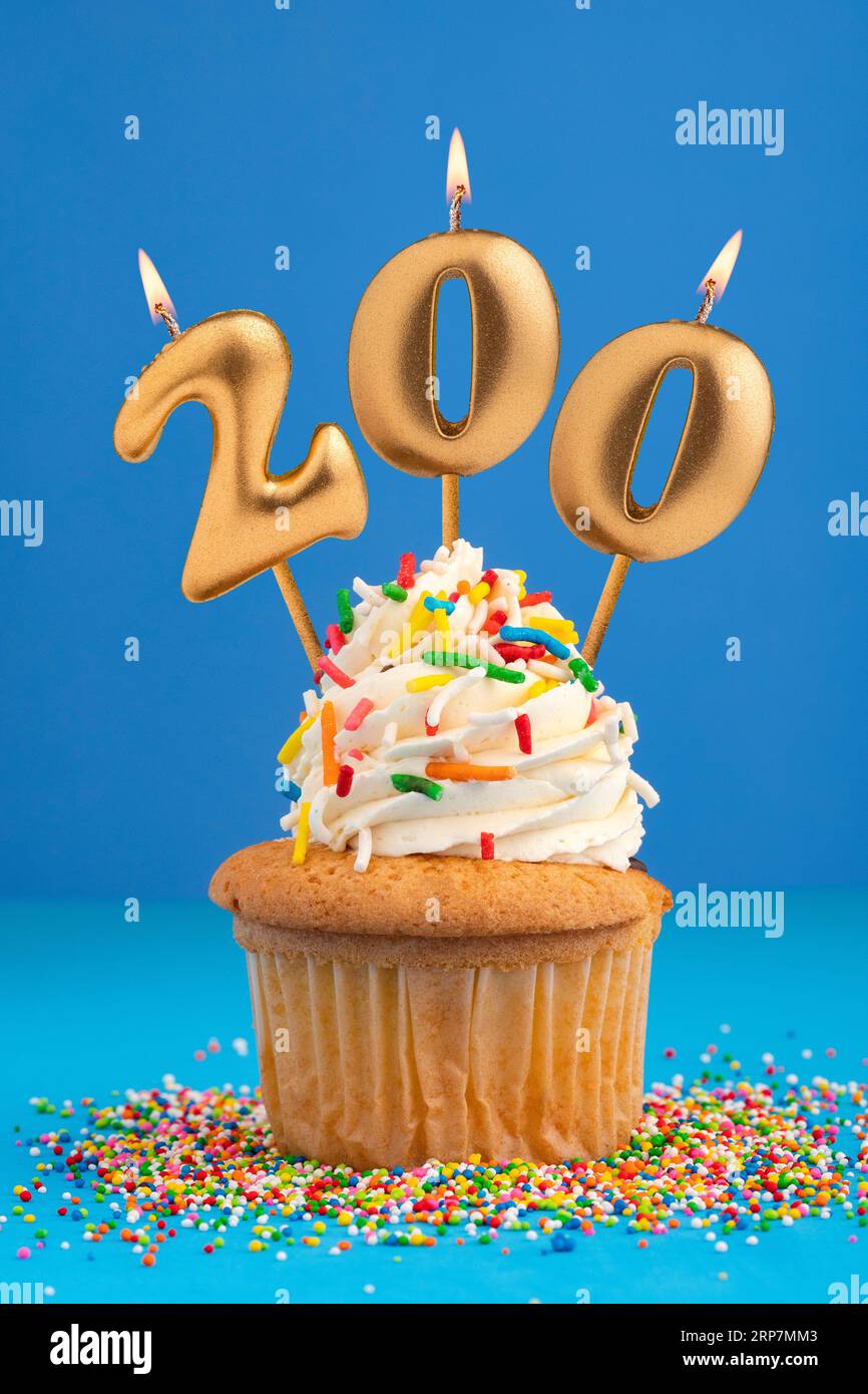 Candle number 200 - Anniversary cupcake on blue background Stock Photo ...