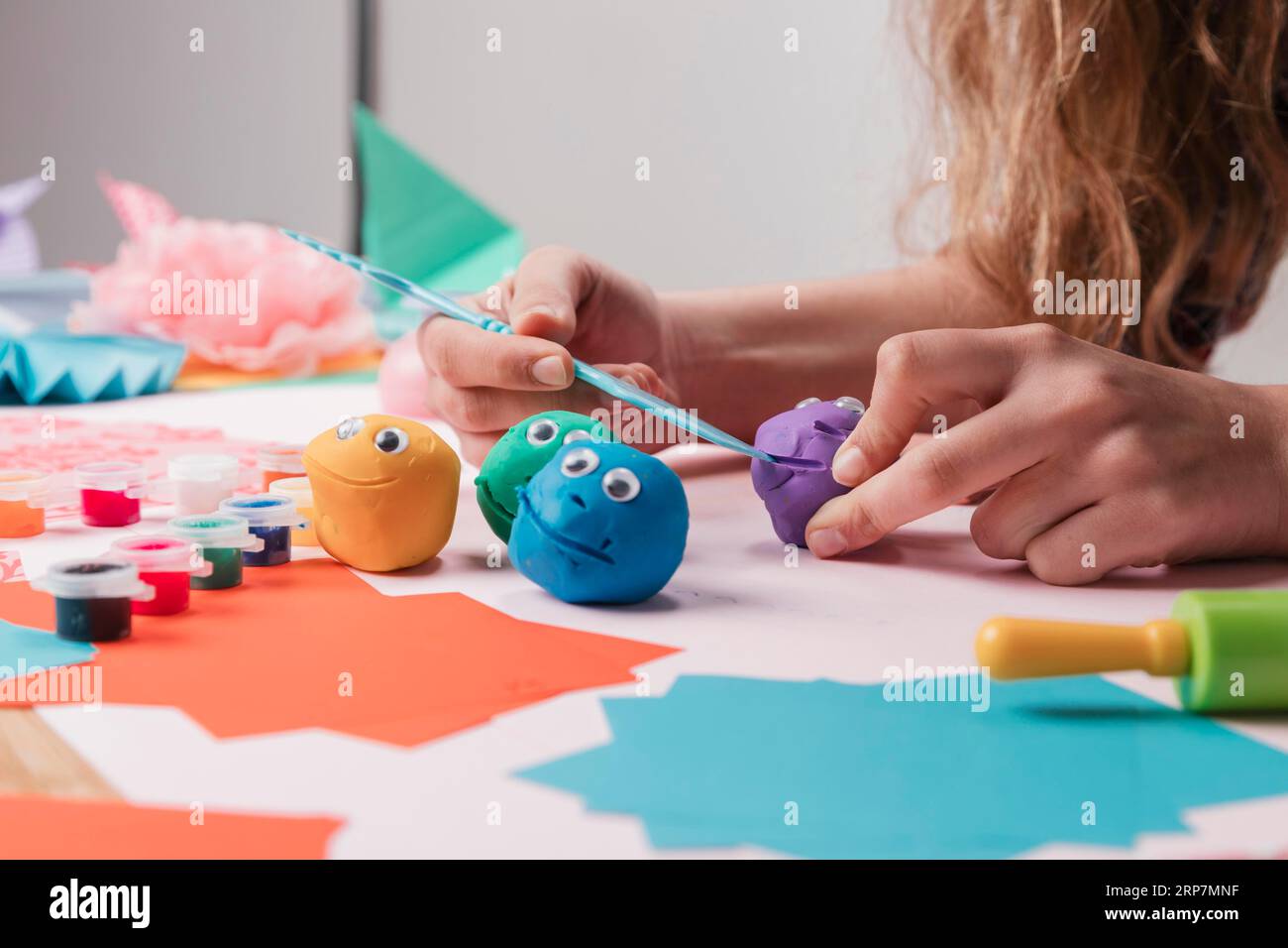 Female artist hand making cartoon faces using craft equipment Stock ...