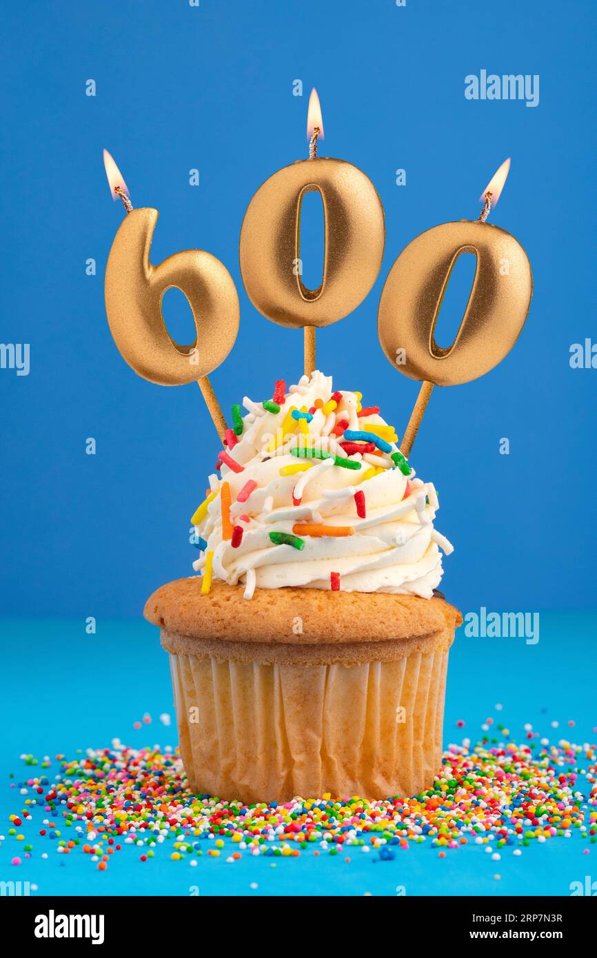 Candle number 600 - Anniversary cupcake on blue background Stock Photo ...