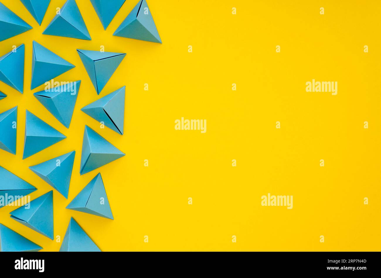 Flat lay vibrant colored paper pyramids with copy space Stock Photo - Alamy
