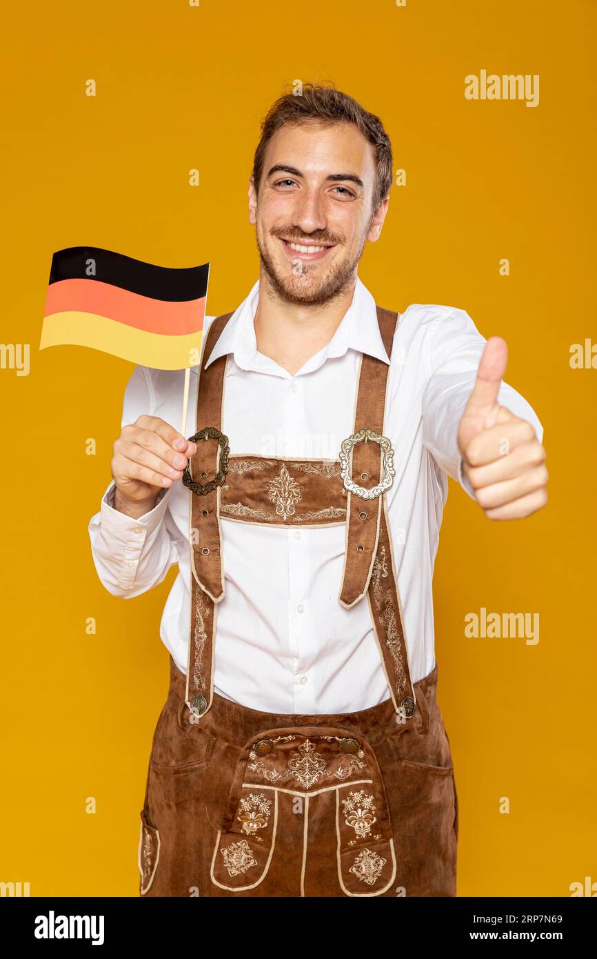 Front view man holding german flag Stock Photo - Alamy