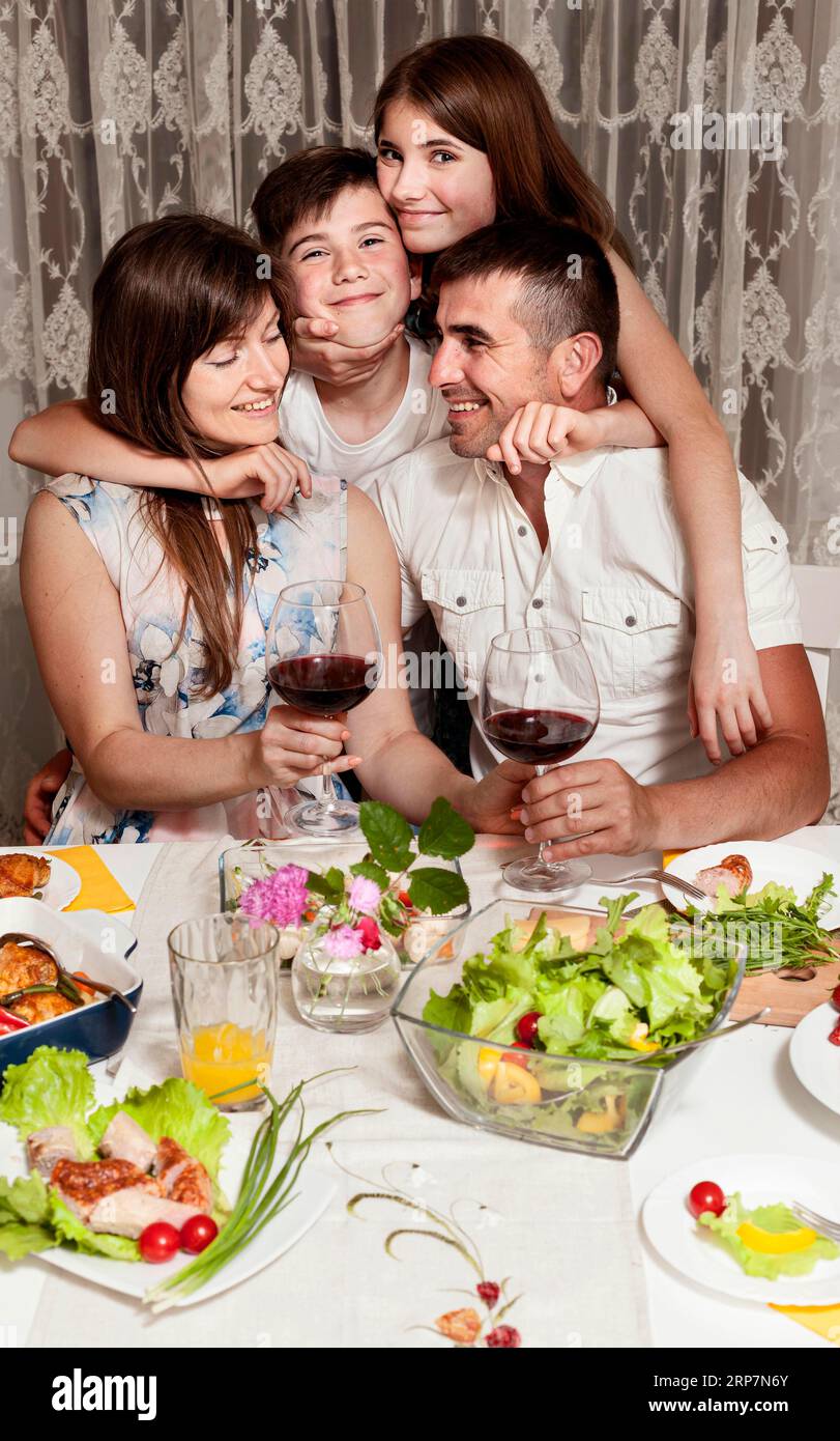 Front view happy family dinner table Stock Photo - Alamy