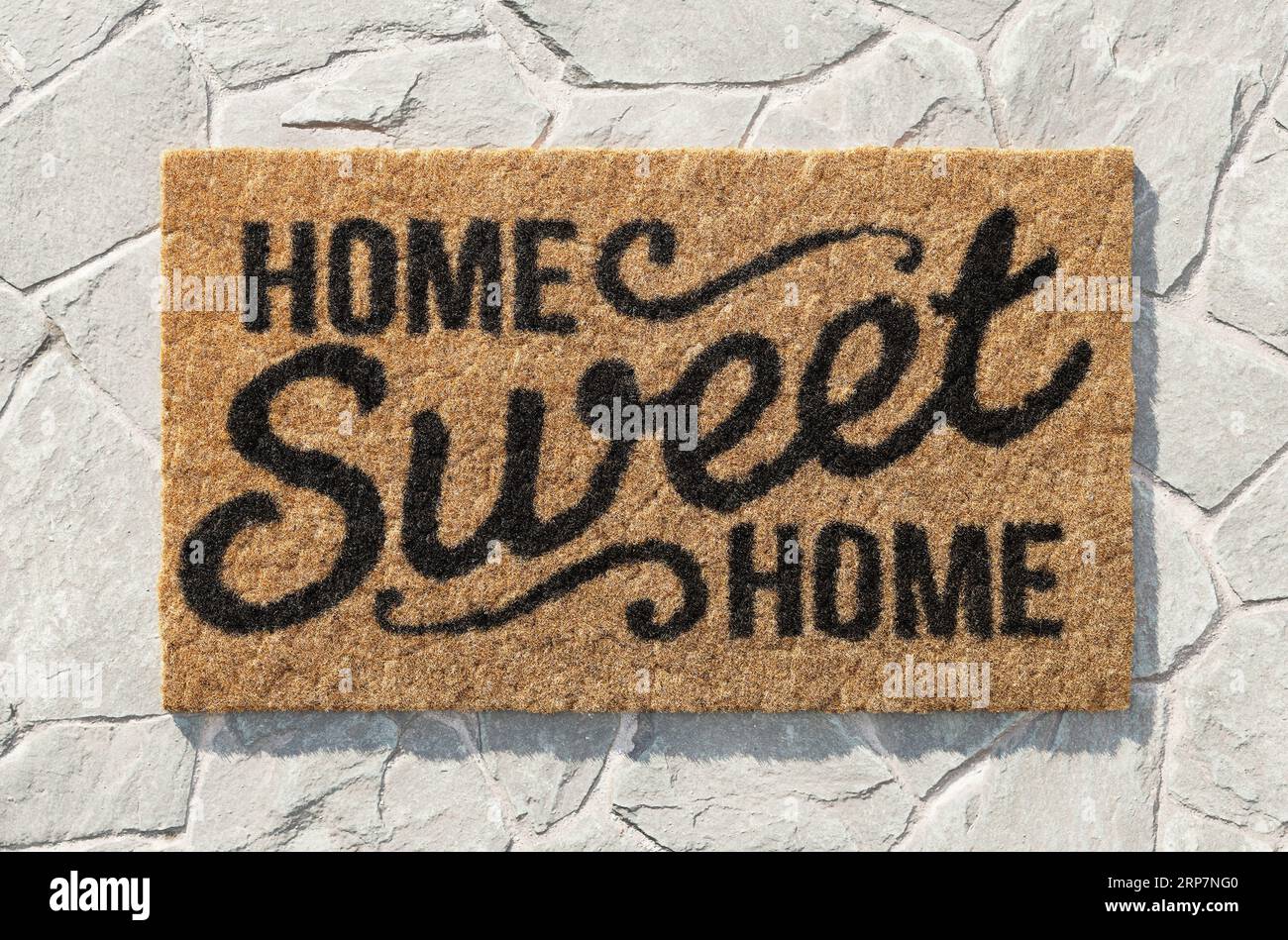 Overhead of Home Sweet Home doormat on the rock tile porch Stock Photo ...