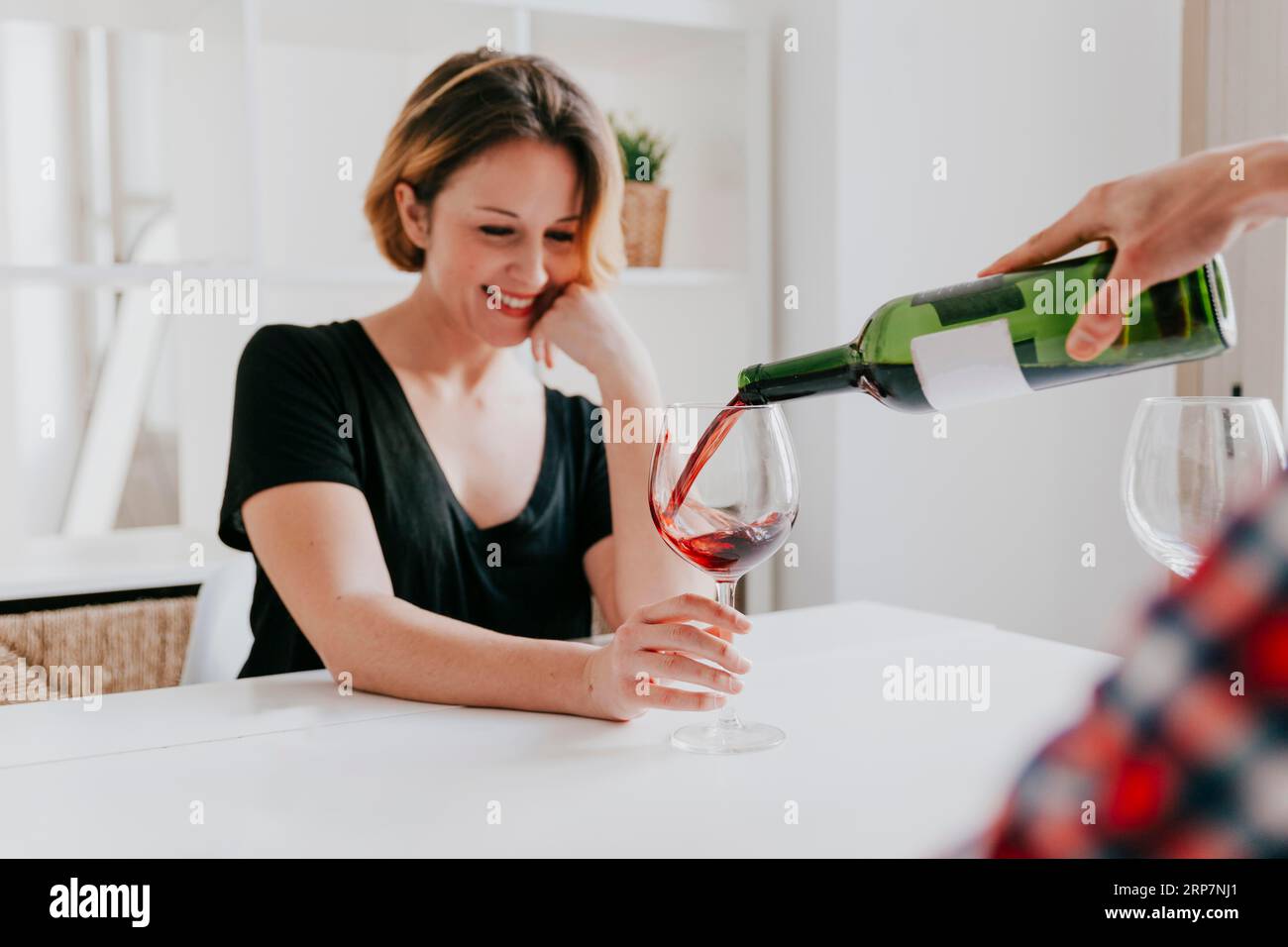 Hand pouring wine girlfriend Stock Photo - Alamy