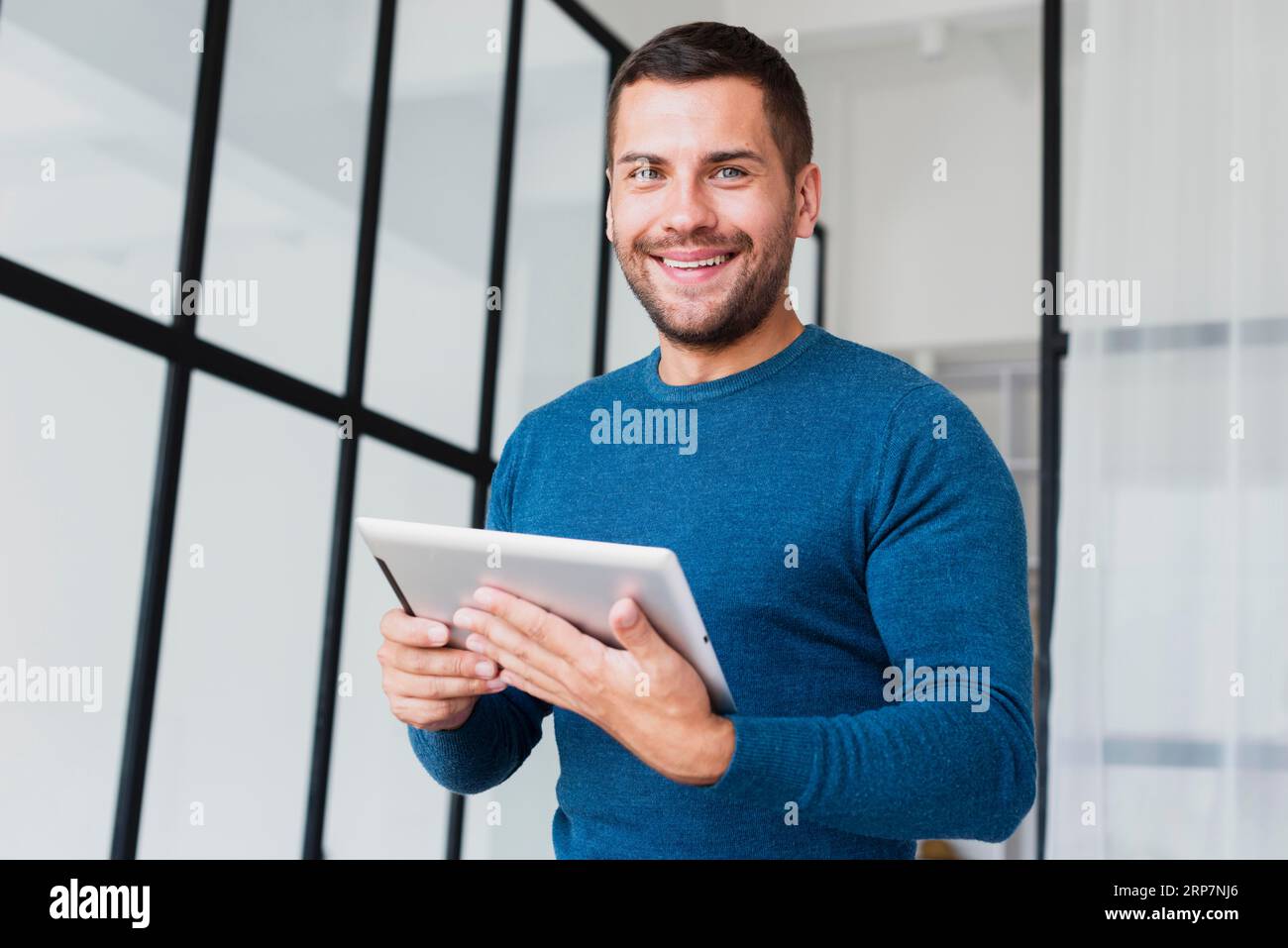 Low angle smilet man with tablet Stock Photo - Alamy