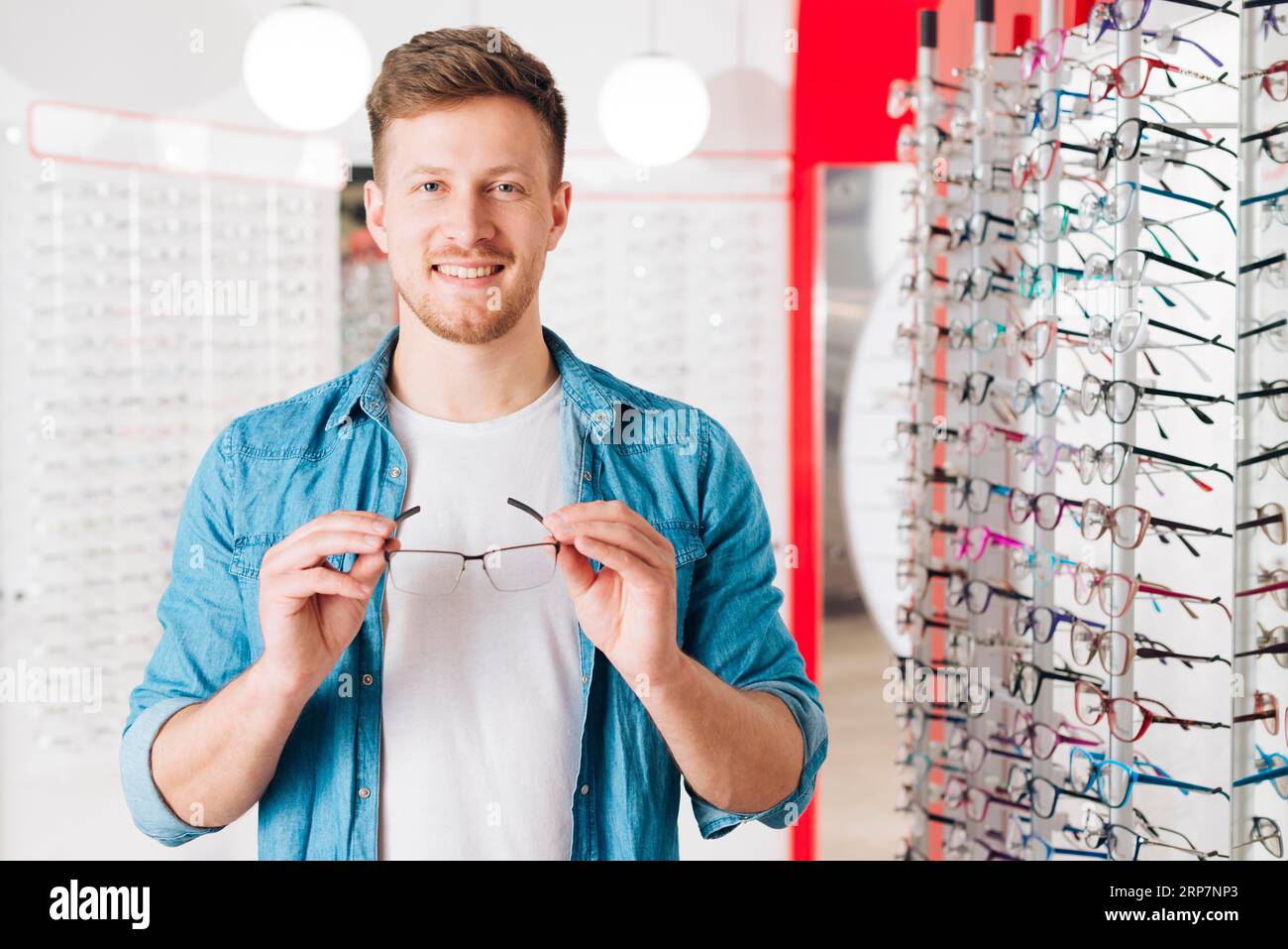 Man looking new glasses optometrist Stock Photo - Alamy