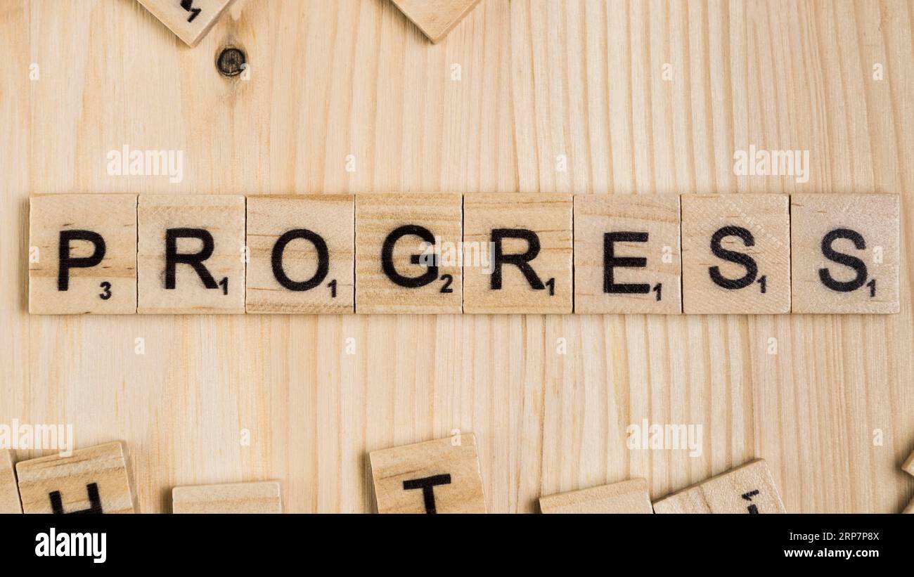 Progress word wooden tiles Stock Photo - Alamy