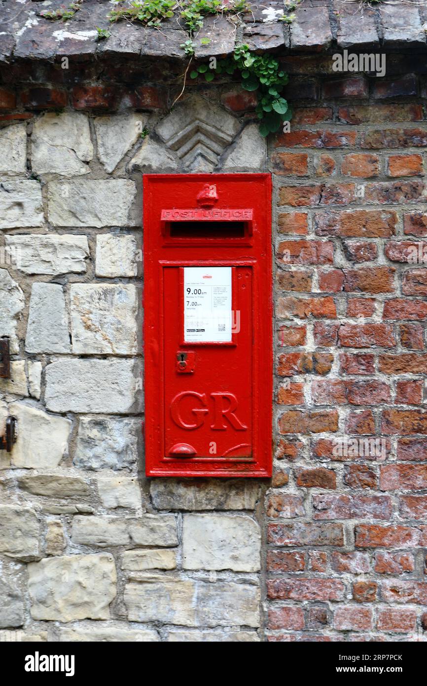 a red king George V post box set into a stone wall Stock Photo - Alamy