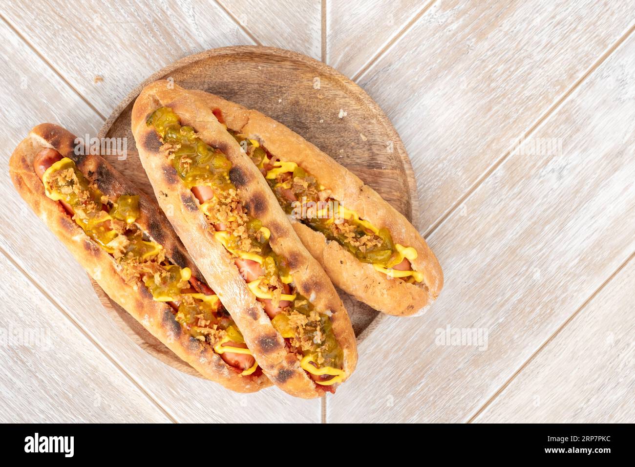Hot dogs fully loaded on a plate. Food background with copy space Stock ...