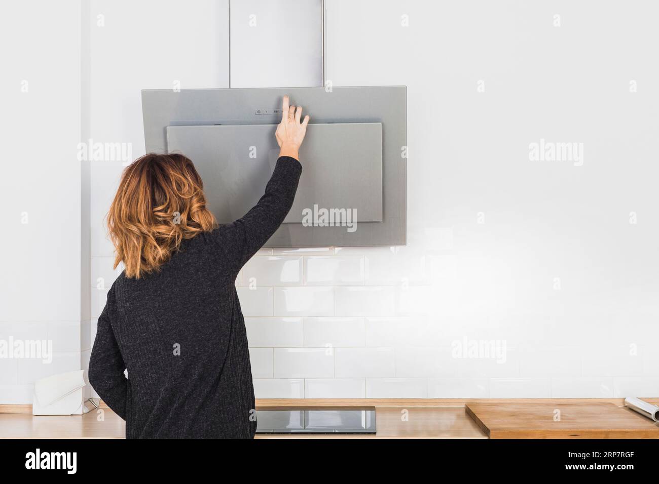Female opening kitchen hoods Stock Photo - Alamy