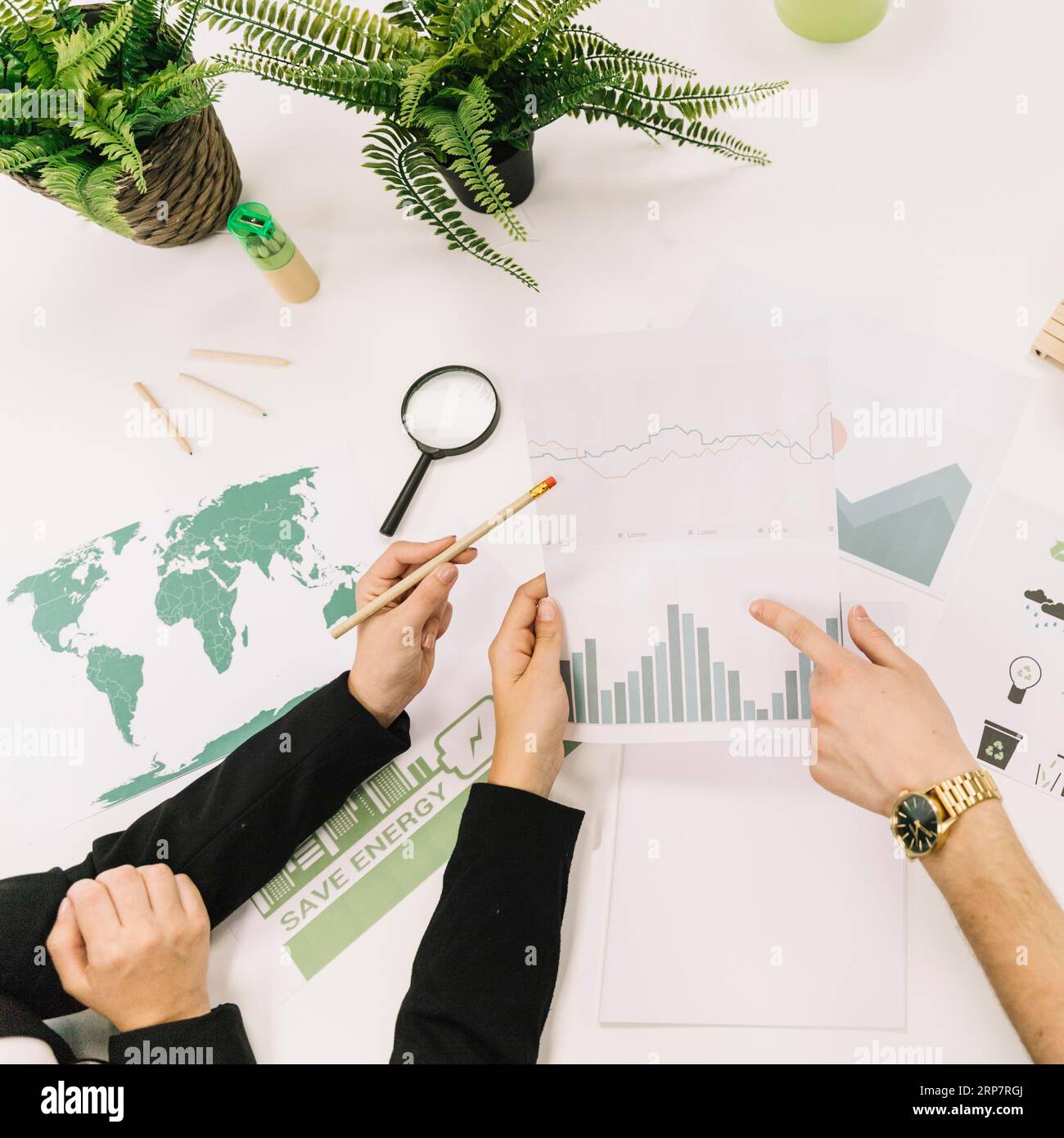 Elevated view businesspeople analyzing graph desk Stock Photo - Alamy
