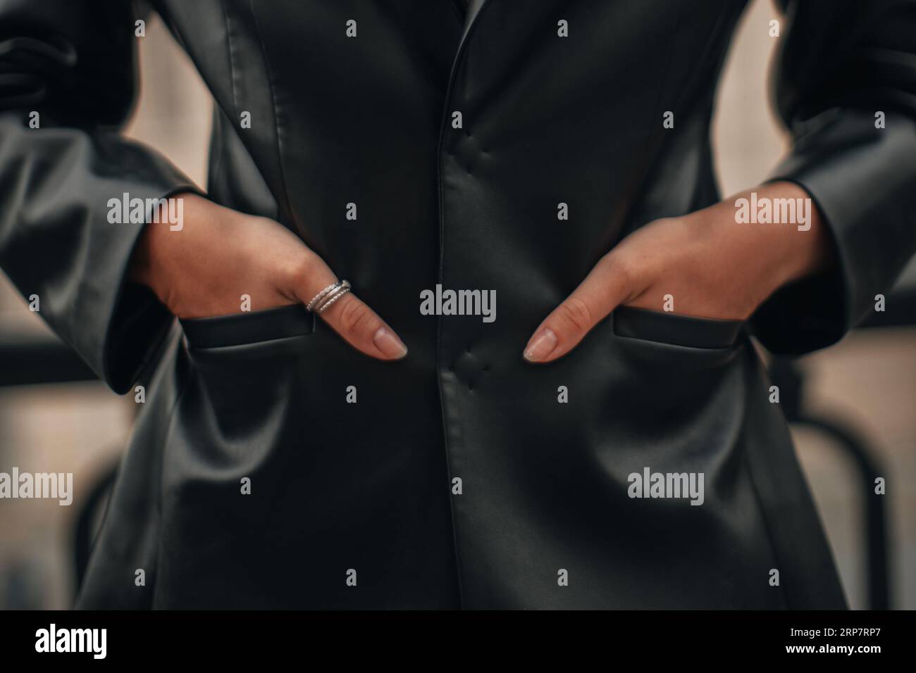 Close up fashion details of a black leather jacket with pockets and ...