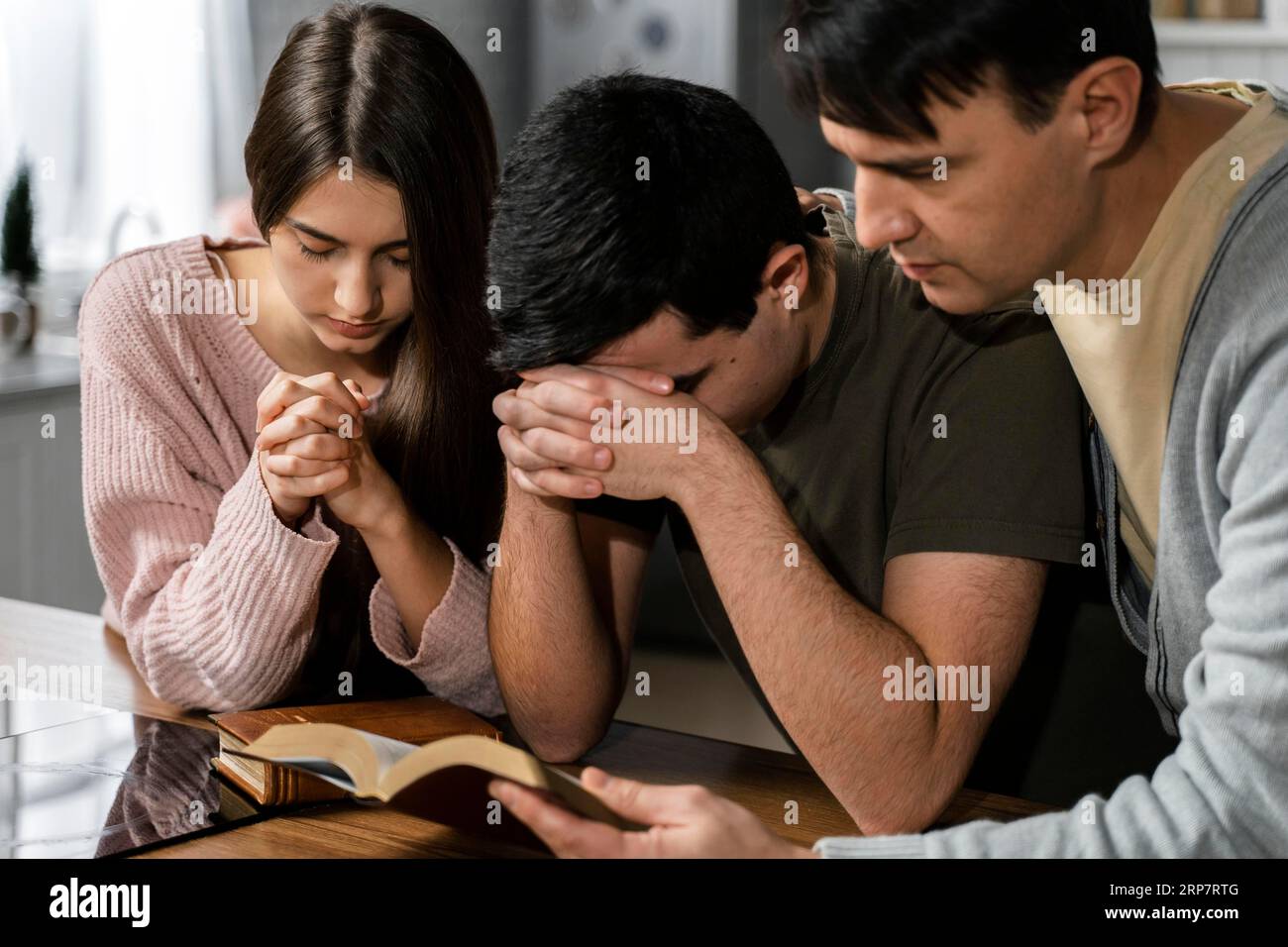 Front view people praying together kitchen Stock Photo - Alamy