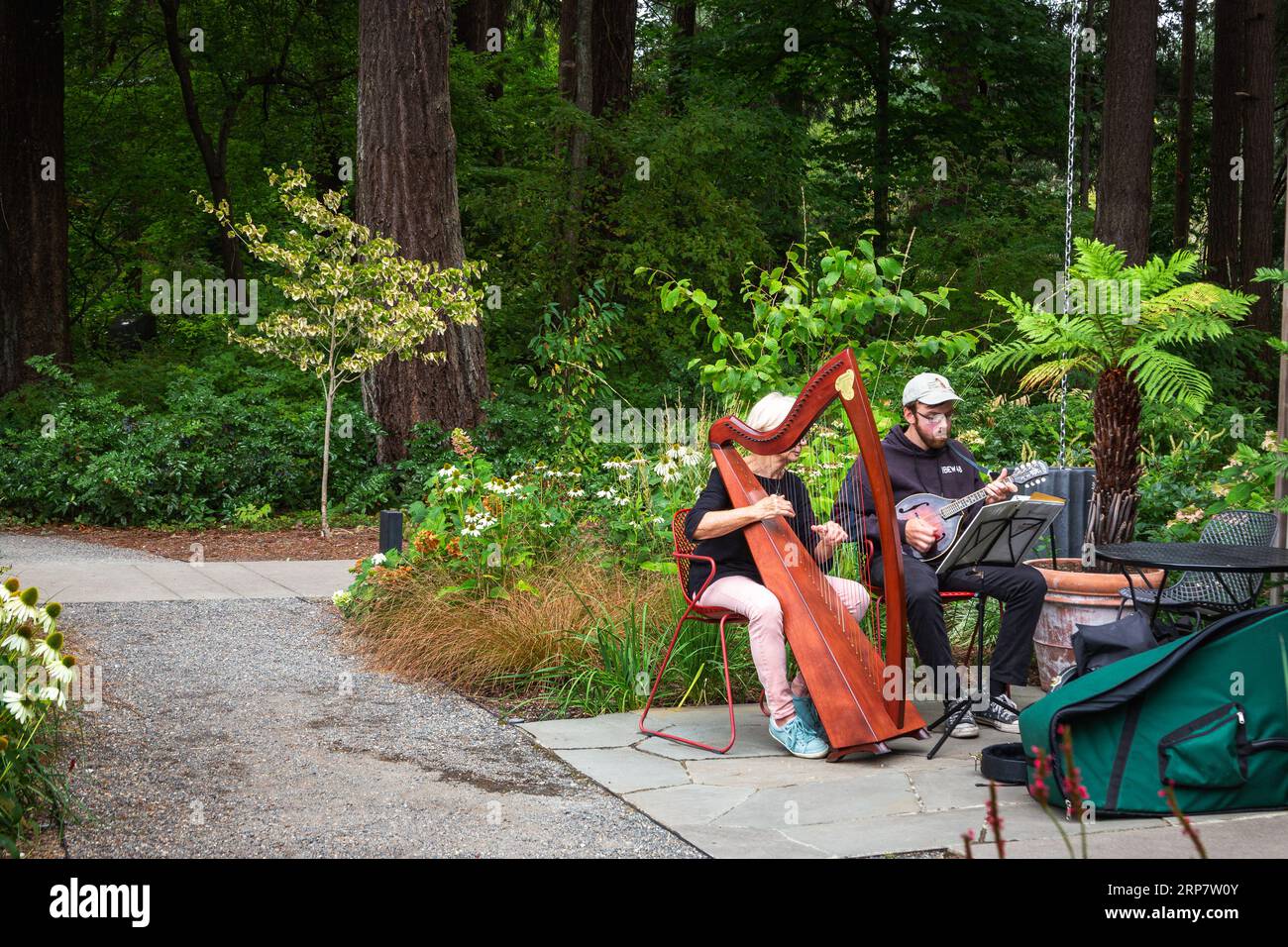 People playing instruments for guests at the Leach Botanical Gardens in ...