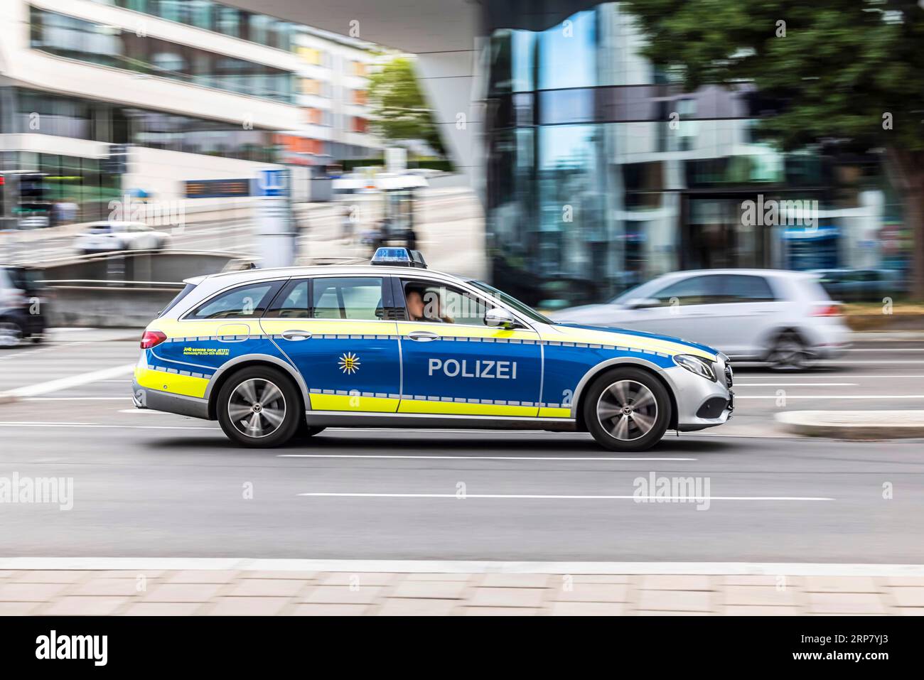 Police vehicle at night in front of urban surroundings, pull-along ...