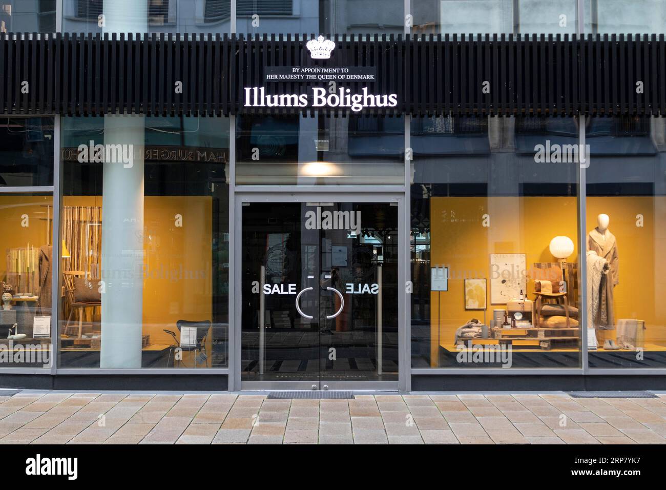Shop window with Sale lettering and facade of the boutique of the Danish luxury brand Illums ...