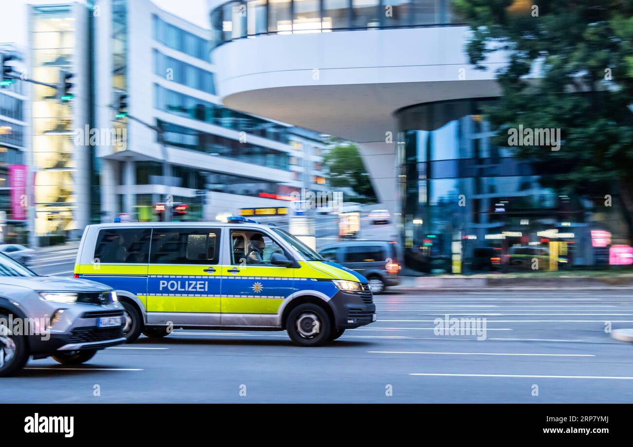 Police vehicle at night in front of urban surroundings, pull-along ...
