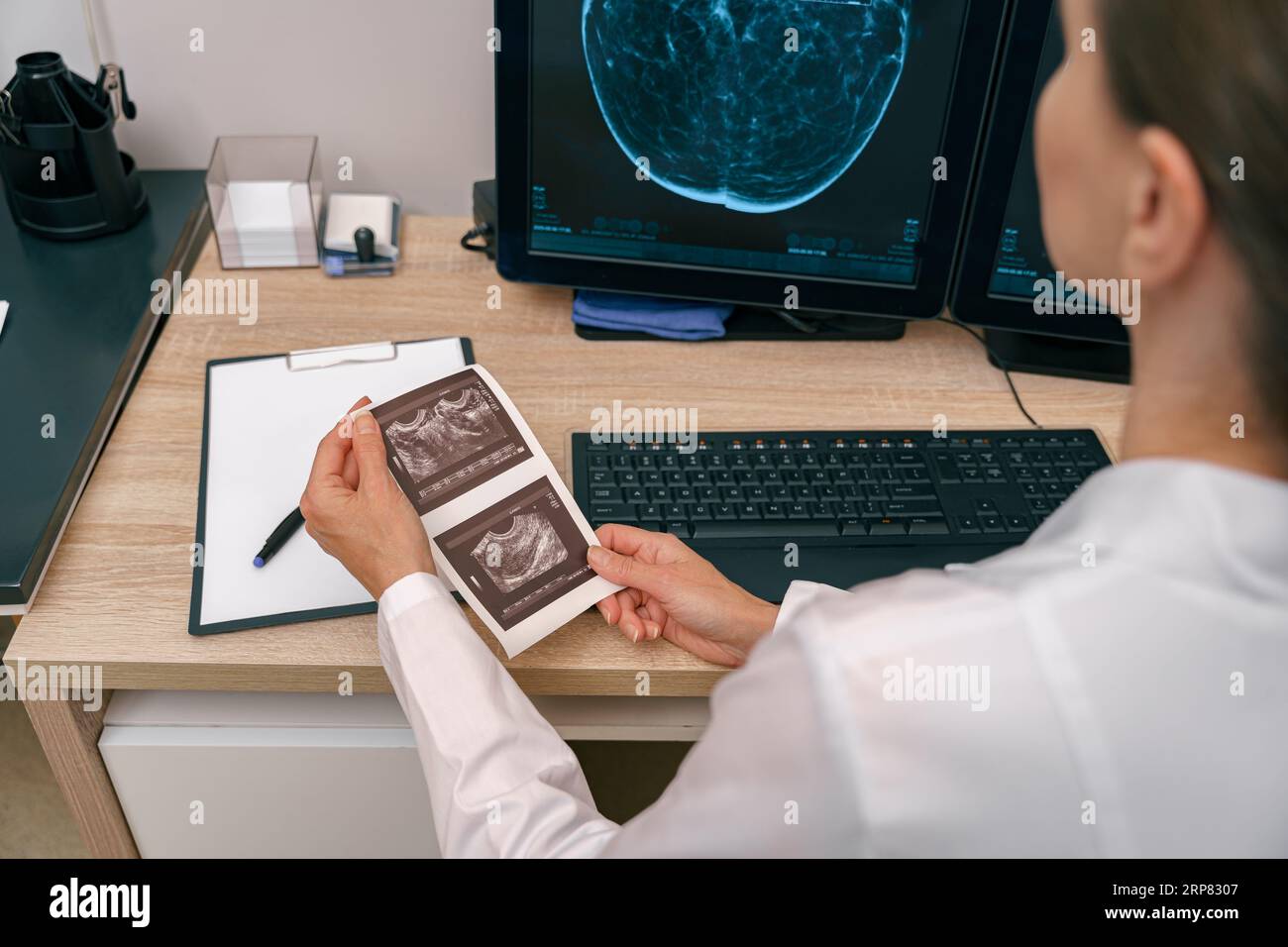 Back view of professional doctor radiologist analyzing scan MRI images ...