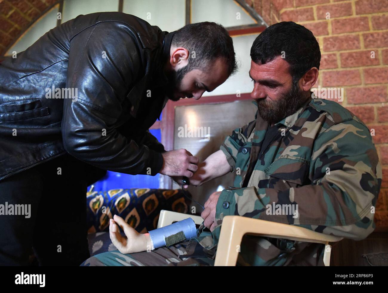 (190220) -- HAMA, Feb. 20, 2019 -- Ali Bakeer (L) installs a prosthetic ...