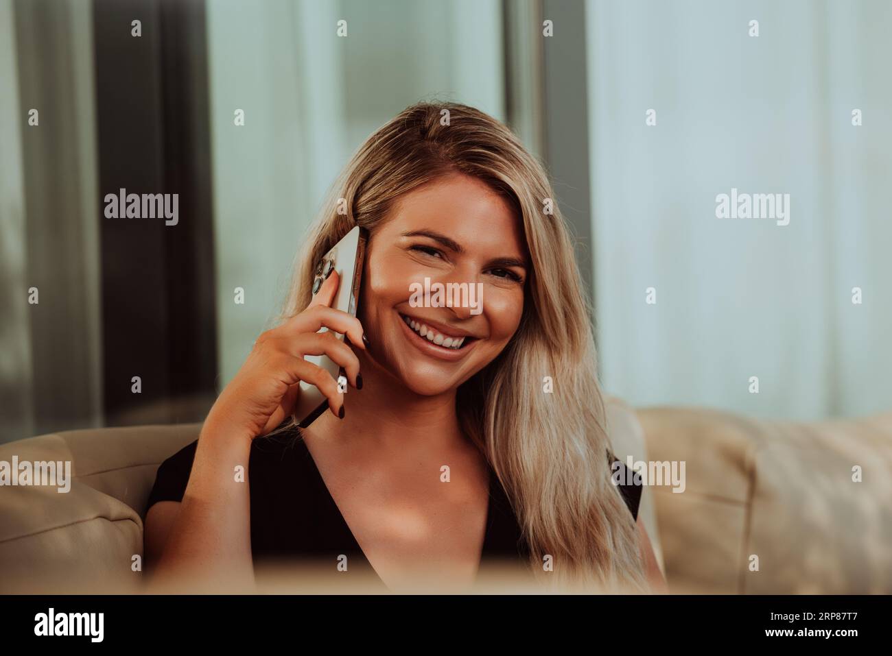 A modern and confident businesswoman, with a cheerful smile, engages in ...