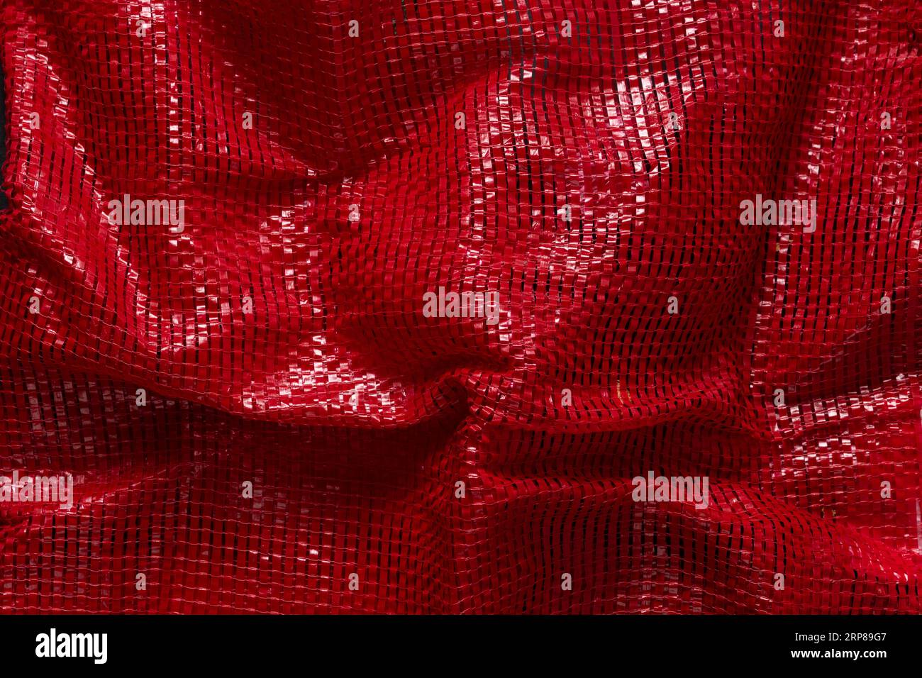 Red woven plastic net for packaging fruits, vegetables, or products ...