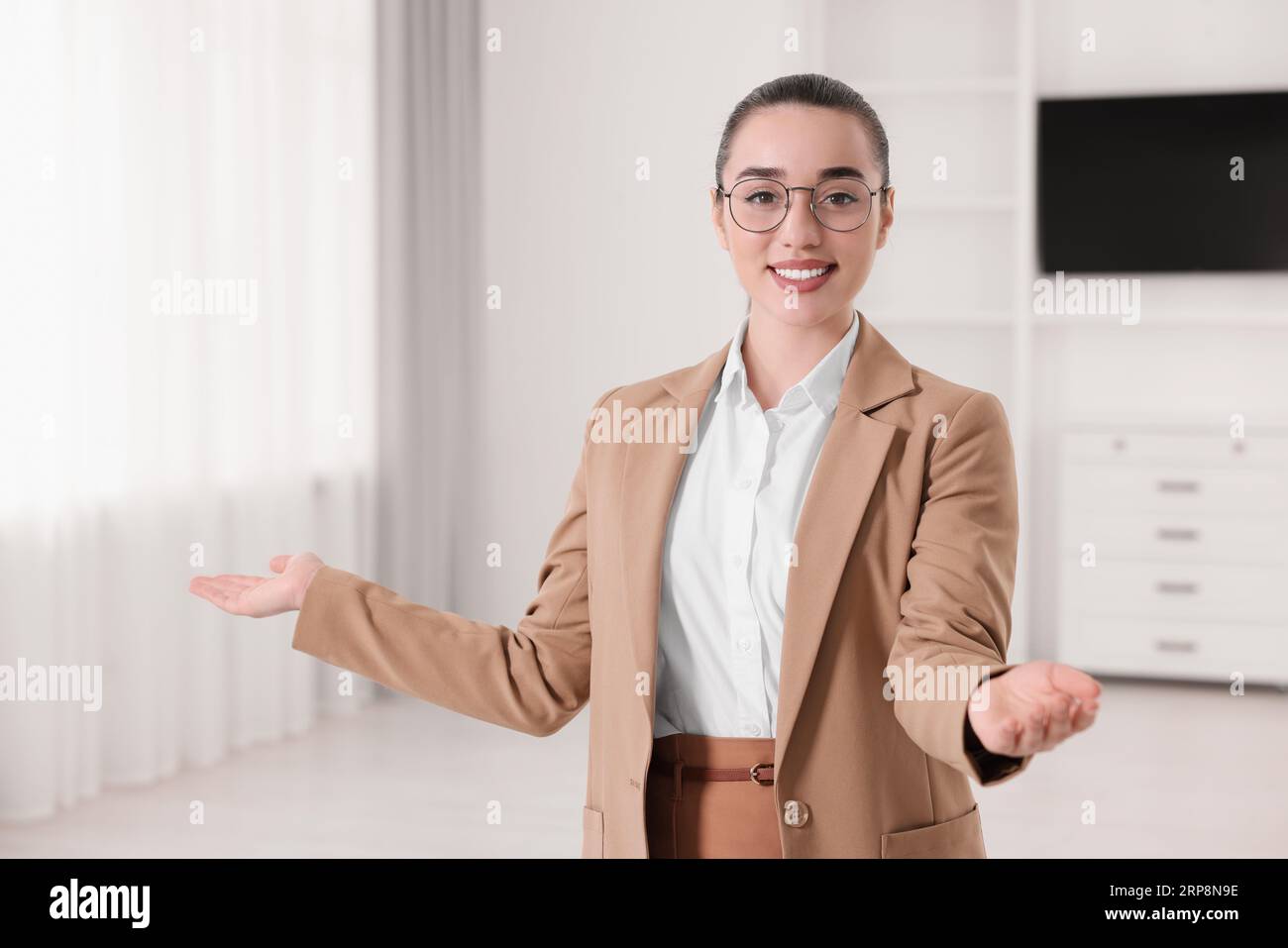 Happy real estate agent showing new apartment Stock Photo - Alamy