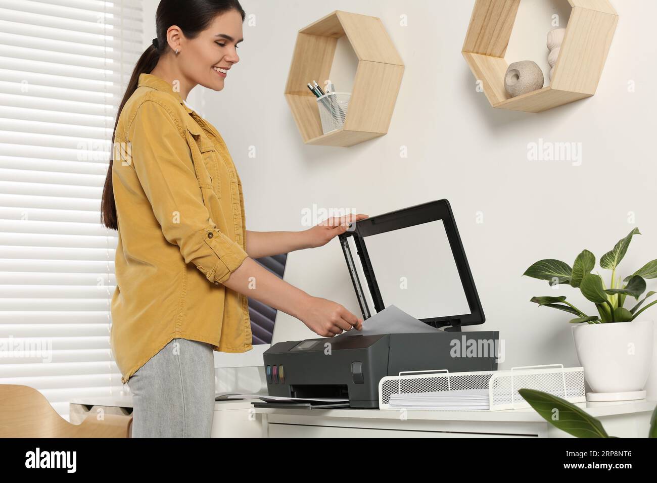 Person using black printer at home hi-res stock photography and images ...