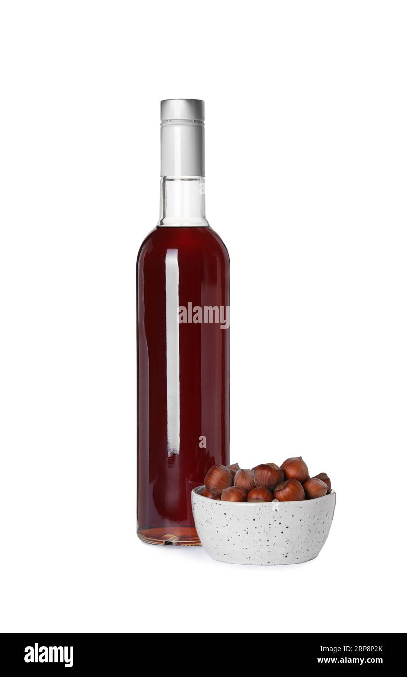 Delicious syrup and bowl of hazelnuts on white background Stock Photo ...