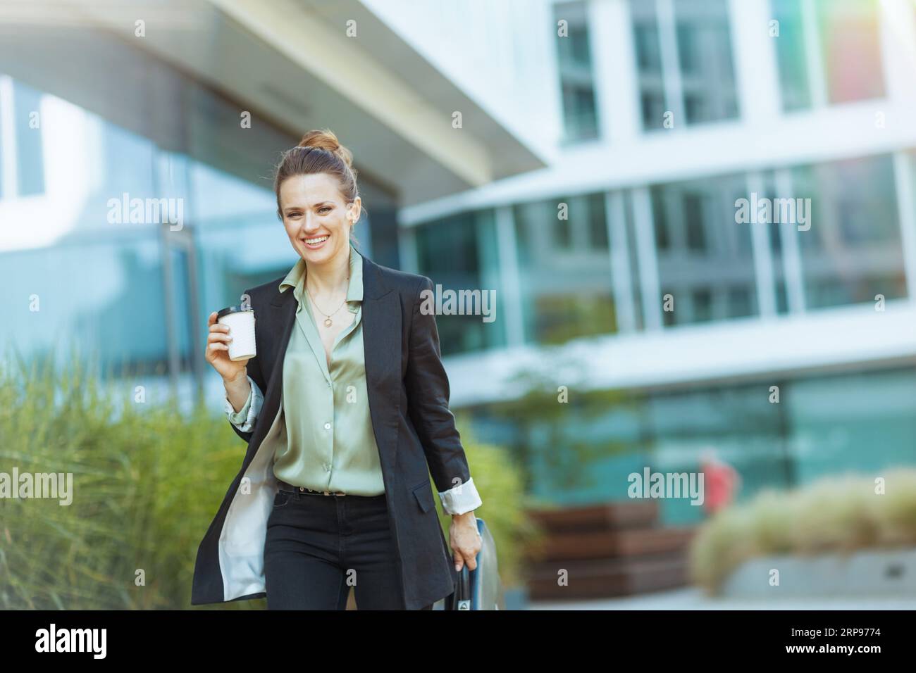 smiling modern 40 years old woman employee near office building in ...