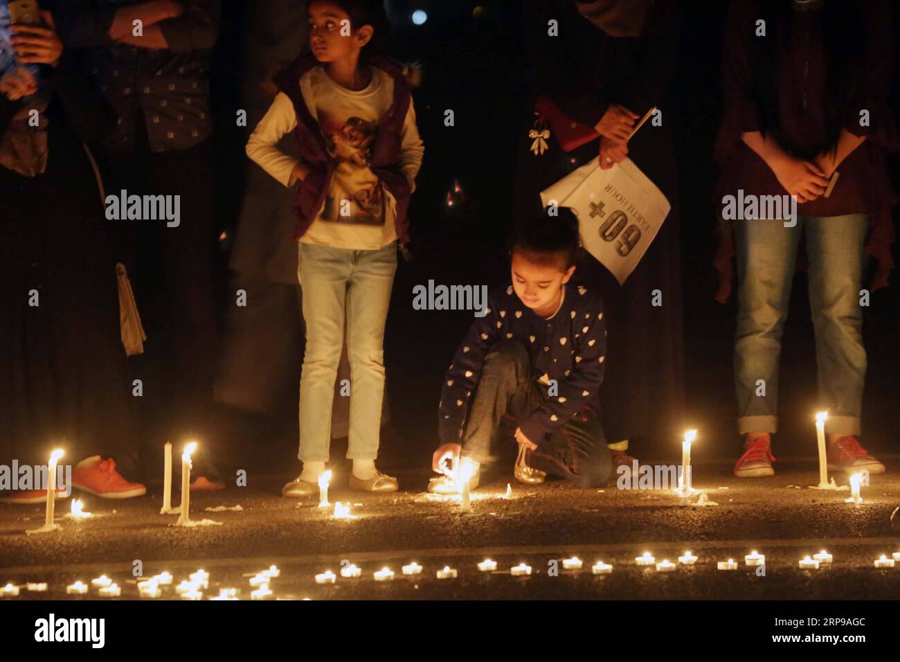 (190330) -- ISLAMABAD, March 30, 2019 -- A girl lights candles during ...