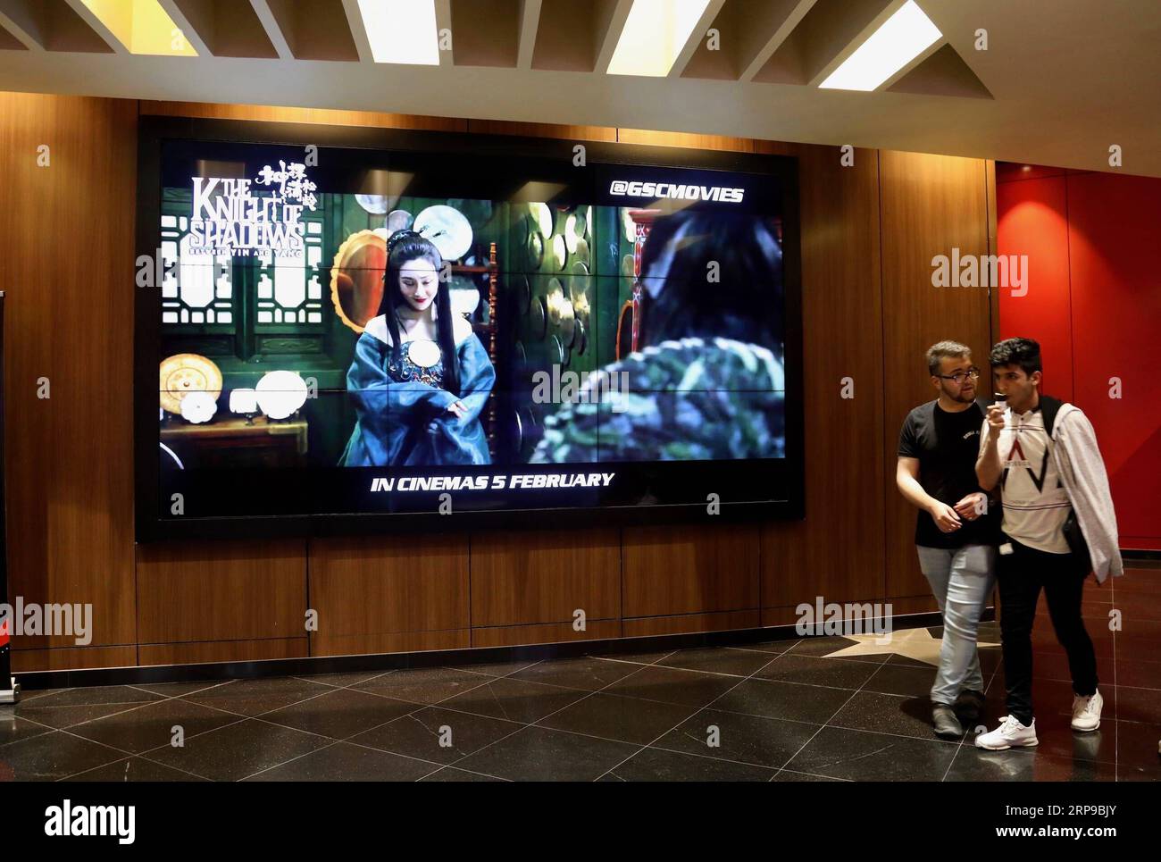 (190401) -- BAGHDAD, April 1, 2019 -- Iraqi movie-goers pass by a ...