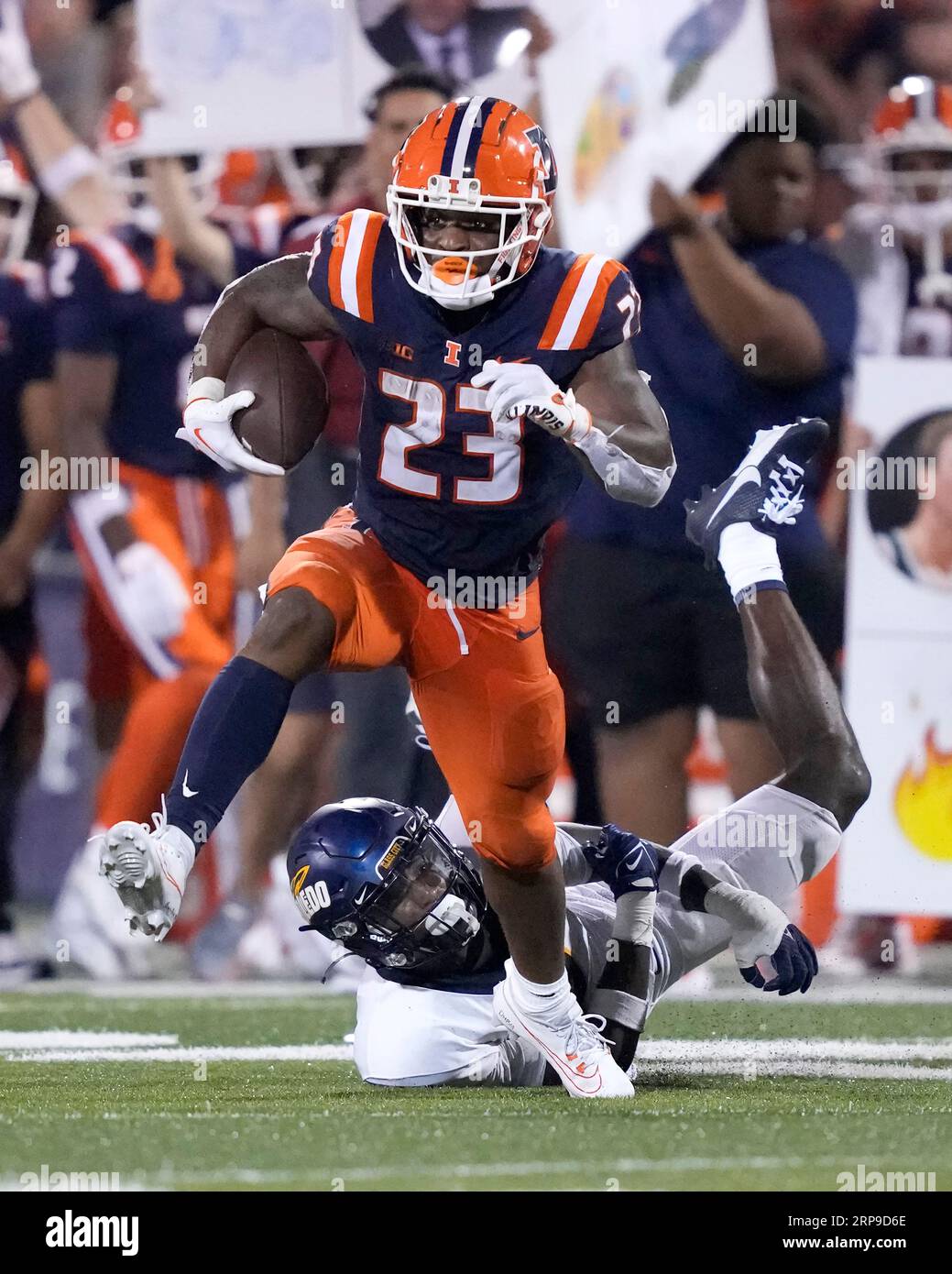 Illinois running back Reggie Love III breaks a tackle during an NCAA ...