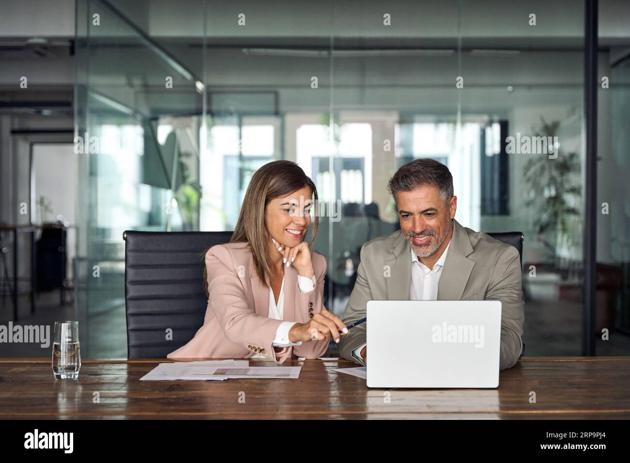 Two business executives discuss digital strategy at office meeting with ...