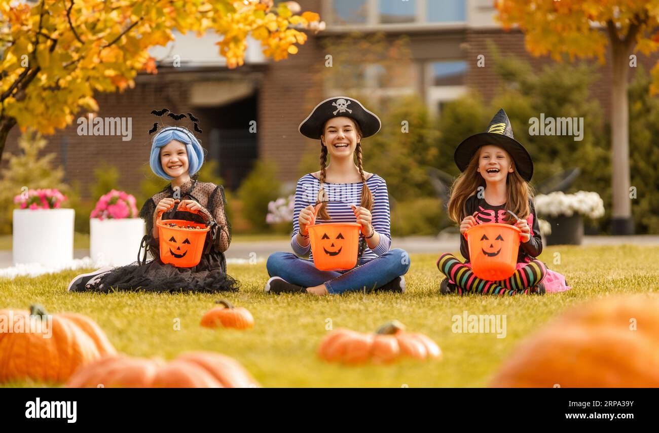 Happy kids at Halloween party. Children are wearing carnival costumes ...