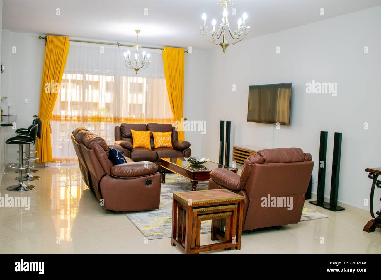 A contemporary living room with bright yellow window curtains and a ...