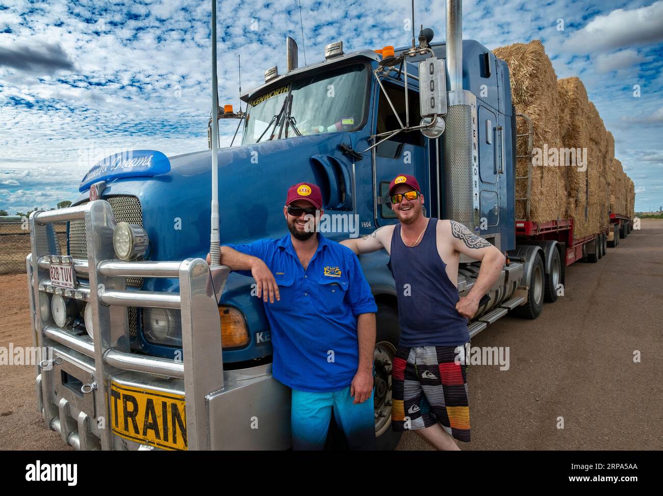 Two truck drivers delivering a load of drought relief fodder to aid ...