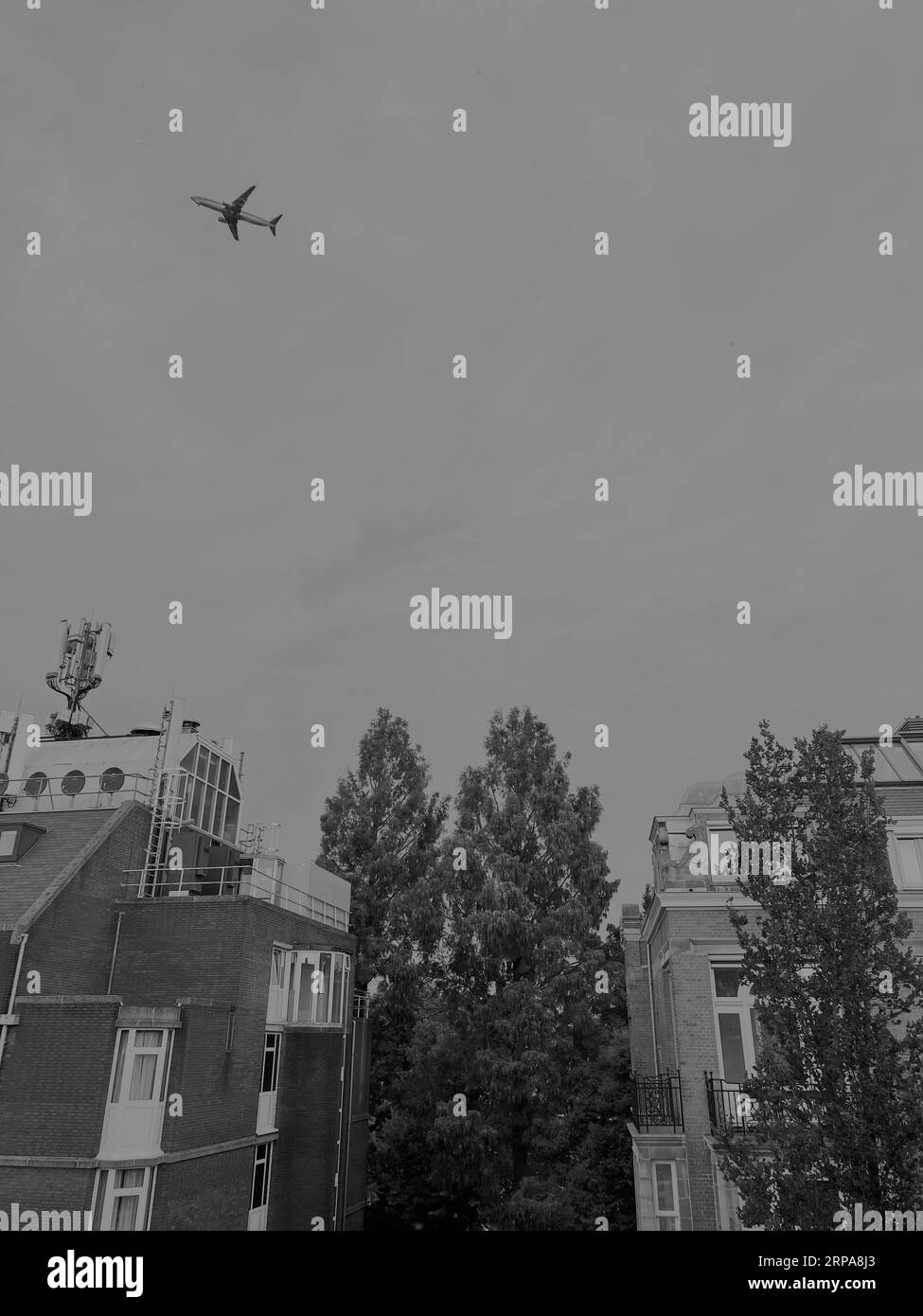 An airplane soaring over a bustling cityscape with an array of high ...