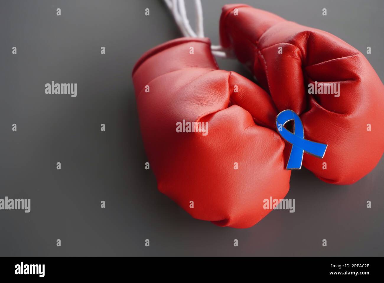 Close up image of boxing gloves and blue ribbon with copy space. Men's ...