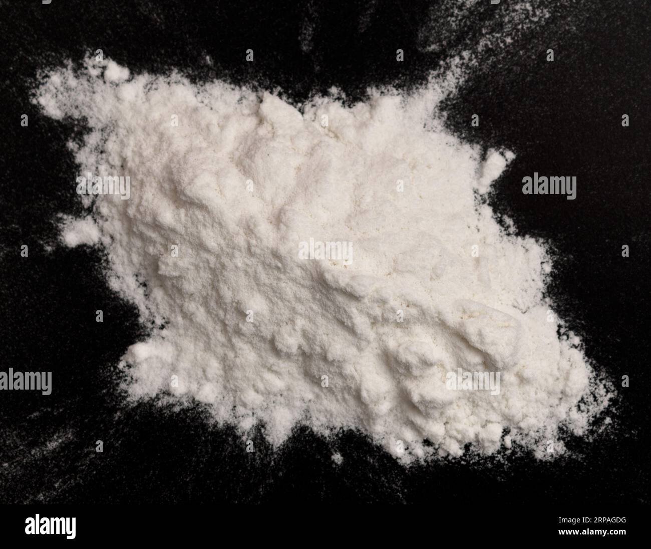 Wheat flour on black background Stock Photo - Alamy