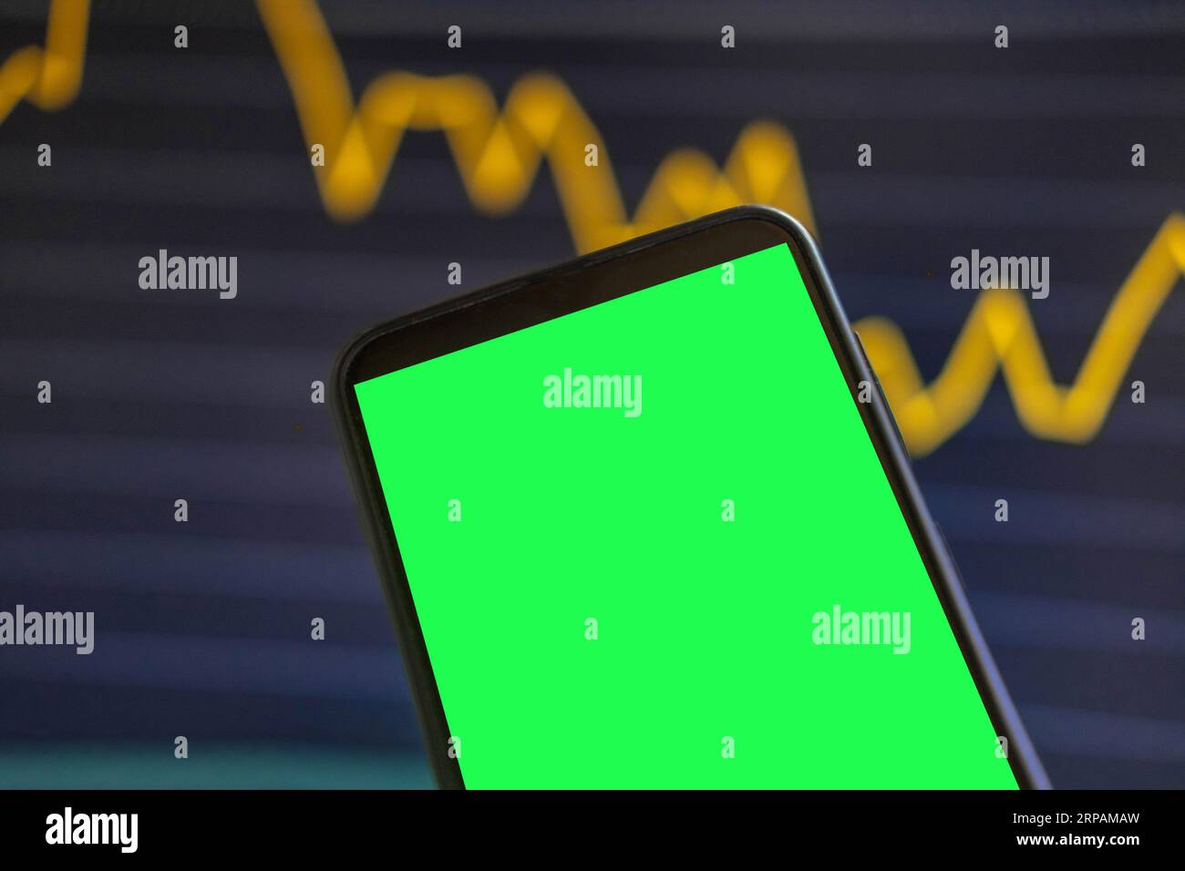 Black phone with blank mockup screen on rising stock graph. Closeup ...