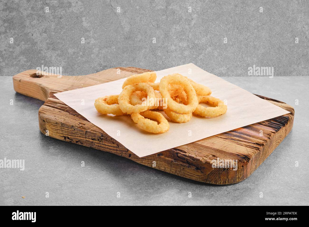 Deep fried spicy onion rings on parchment Stock Photo - Alamy