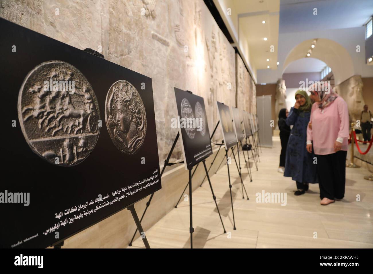 (190520) -- BAGHDAD, May 20, 2019 -- Visitors look at pictures of ...
