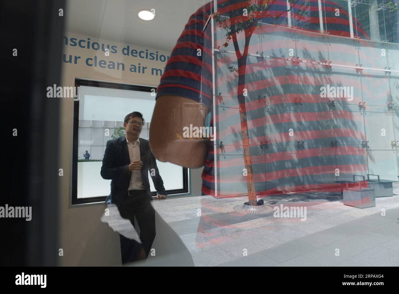 (190521) -- SINGAPORE, May 21, 2019 -- People smoke inside a smoking ...