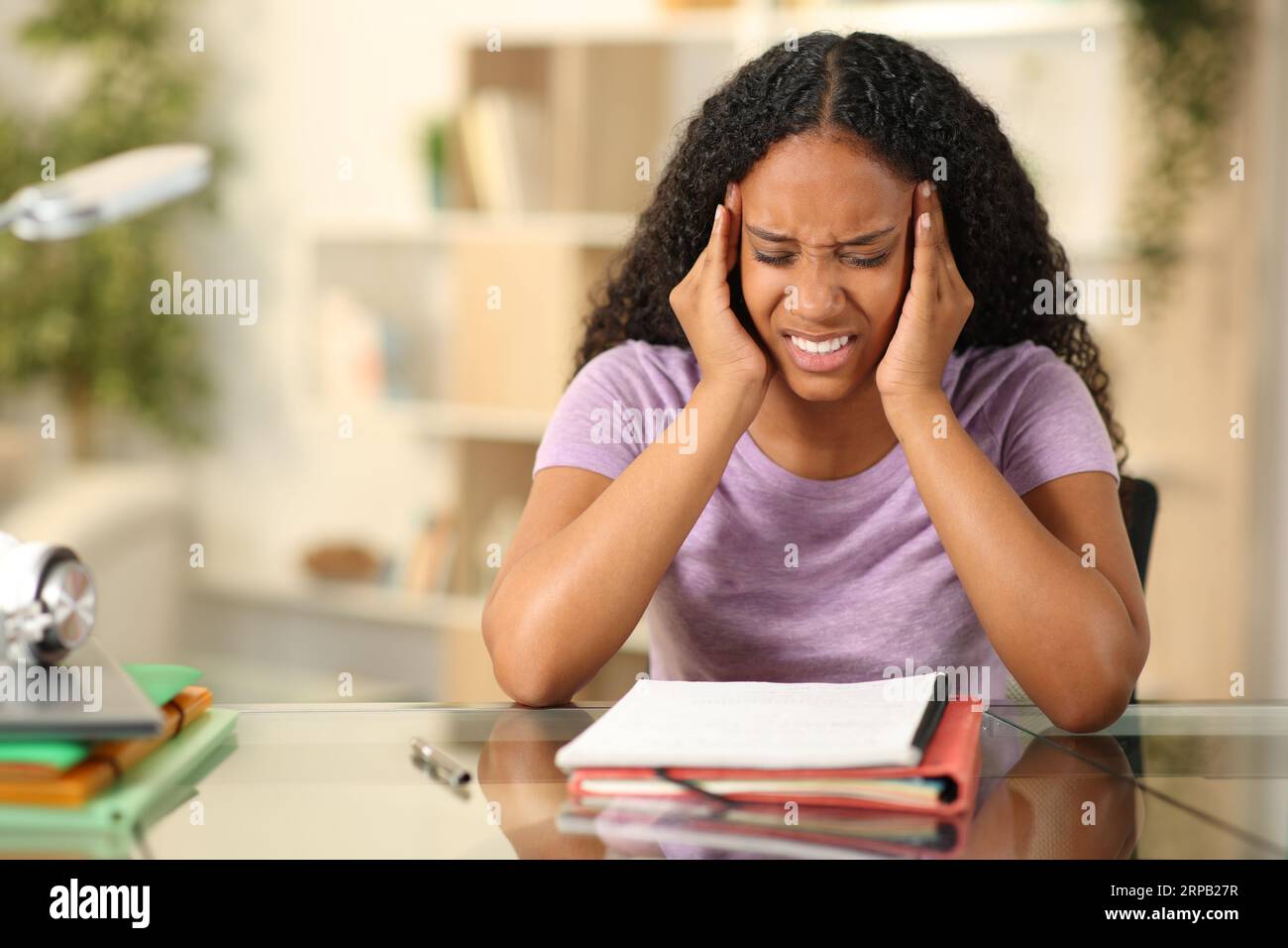 Black student suffering head ache studying memorizing notes at home ...